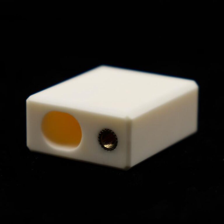 Aluminum oxide ceramic structural component with circular grooves and threaded holes inside the ...